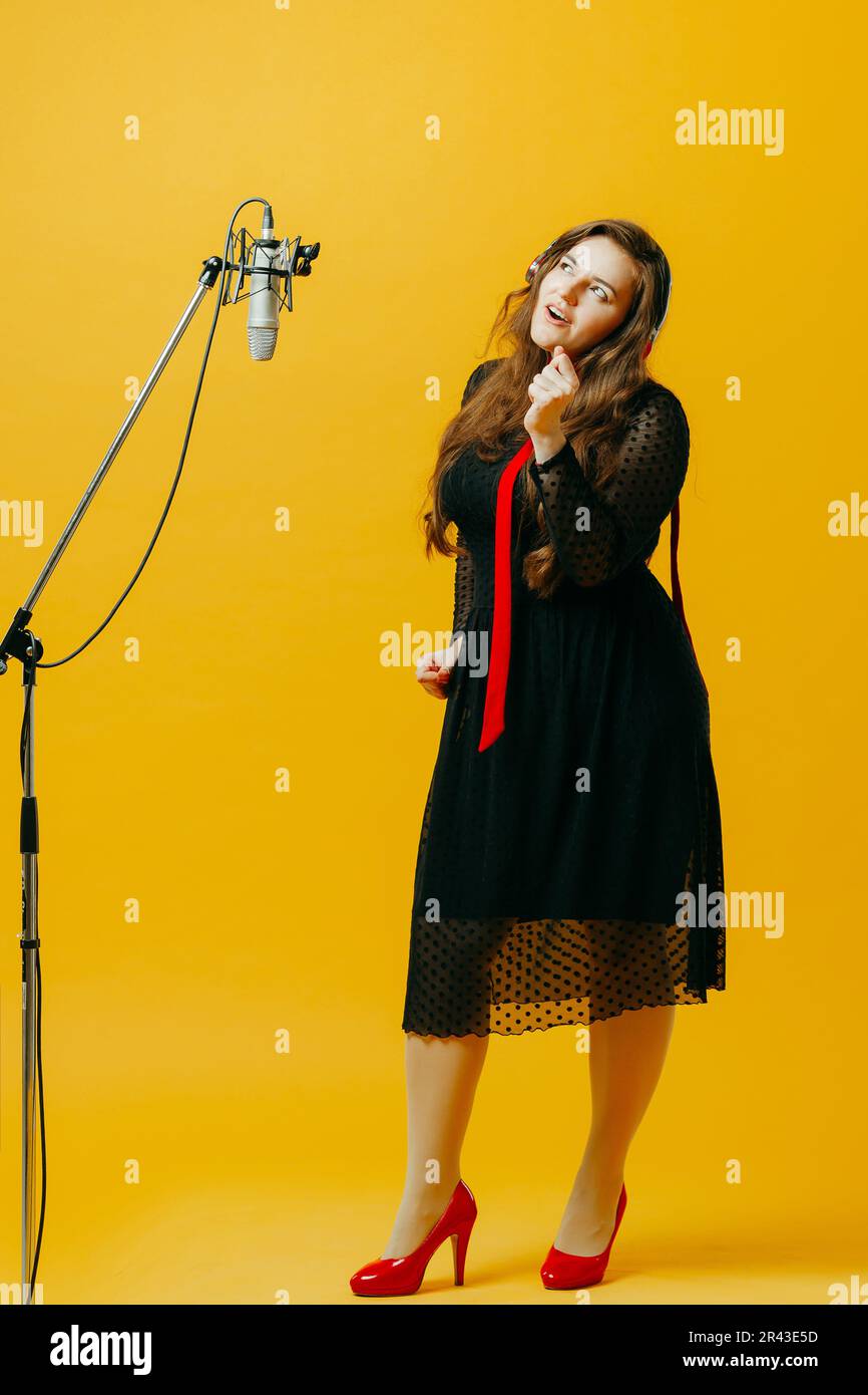 The positive amusing brunette female singer having fun sings song ...