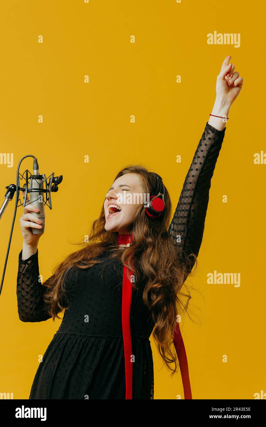 The positive amusing brunette female singer having fun sings song ...