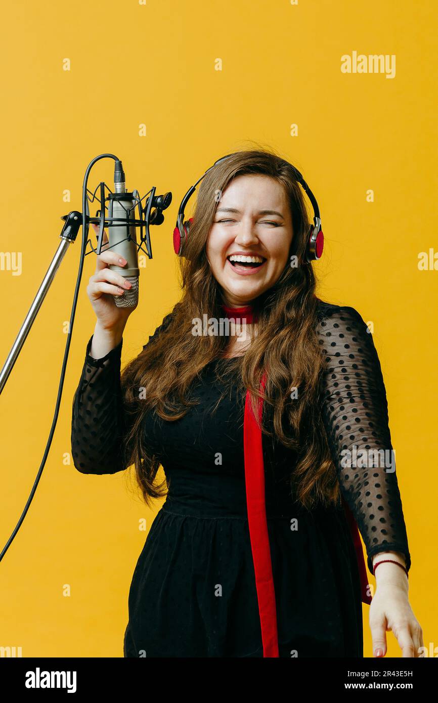 The positive amusing brunette female singer having fun sings song ...