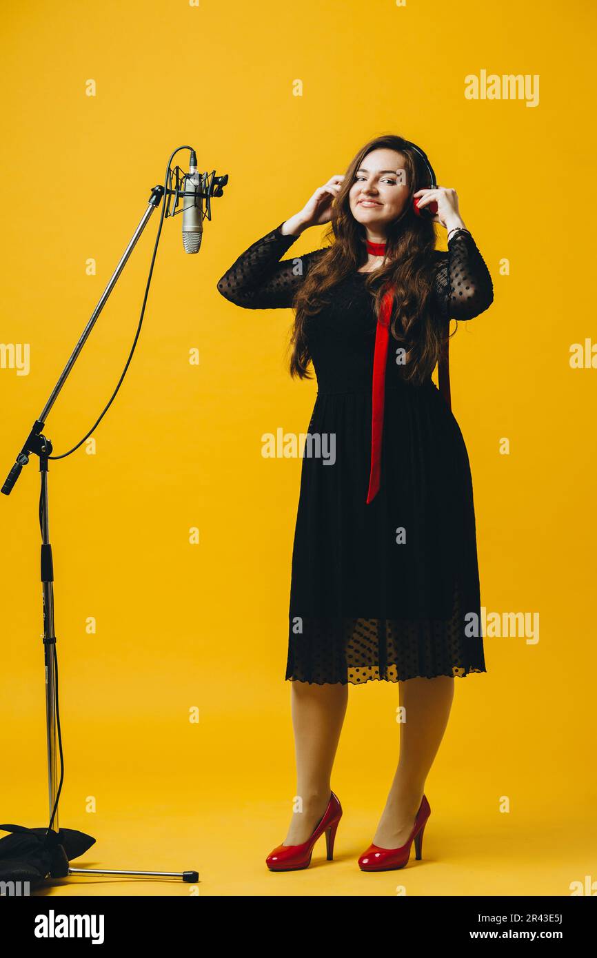 The positive amusing brunette female singer having fun sings song ...