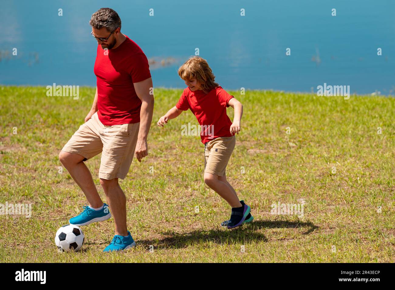 Father and son playing soccer football together. Father and son hours ...