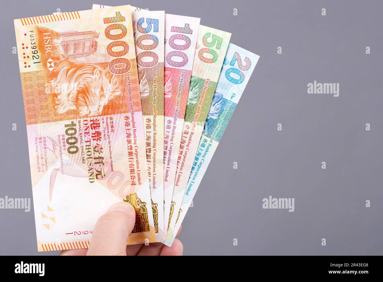 Hong Kong money - dollar in the hand on a gray background Stock Photo ...