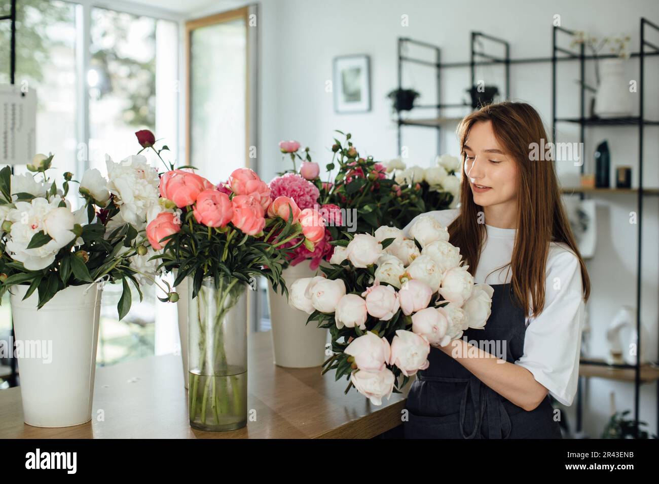 Florist woman in workspace of flower shop. - stock photo Stock Photo ...