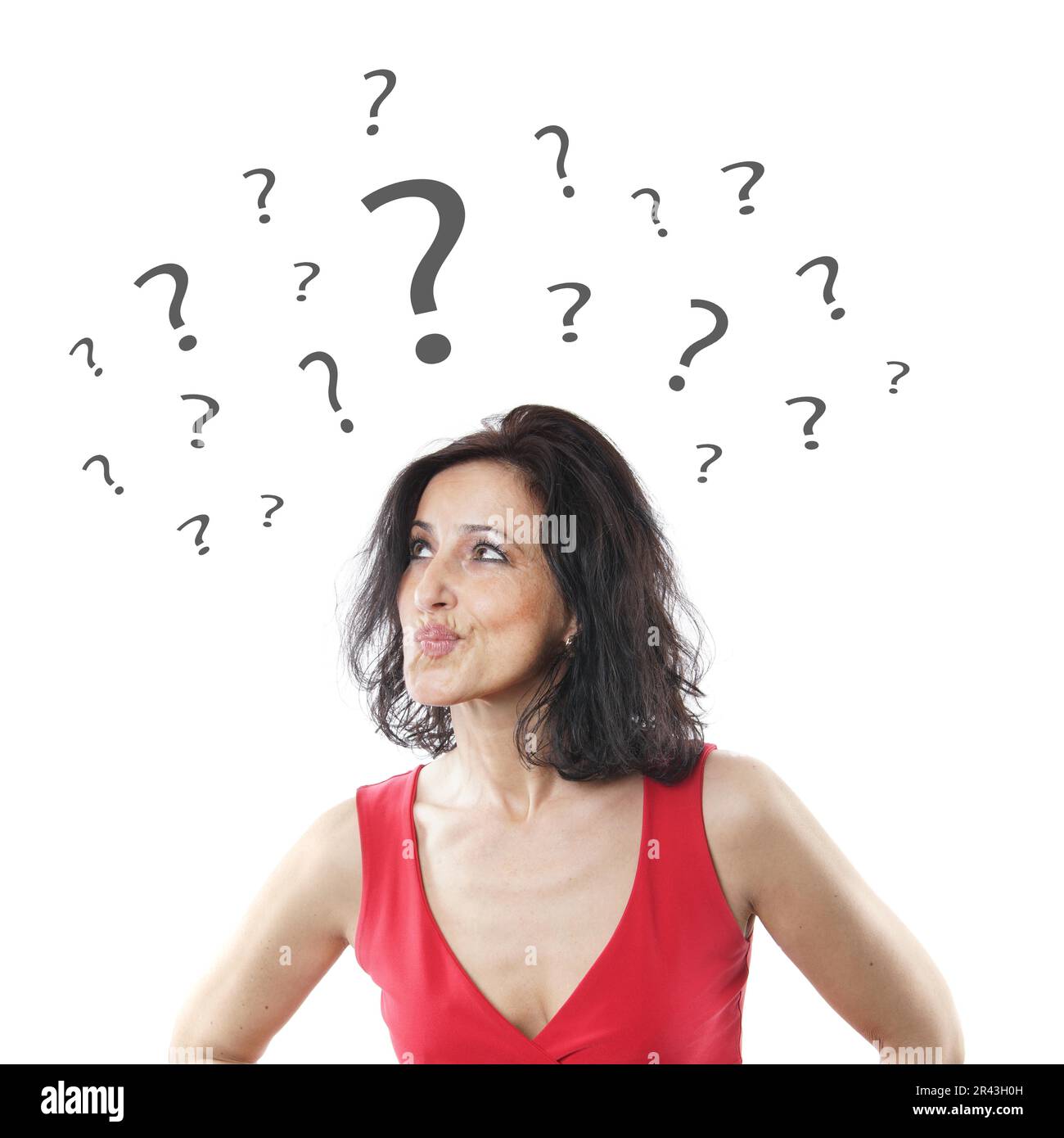 indecisive woman in her forties pouting with question marks Stock Photo ...