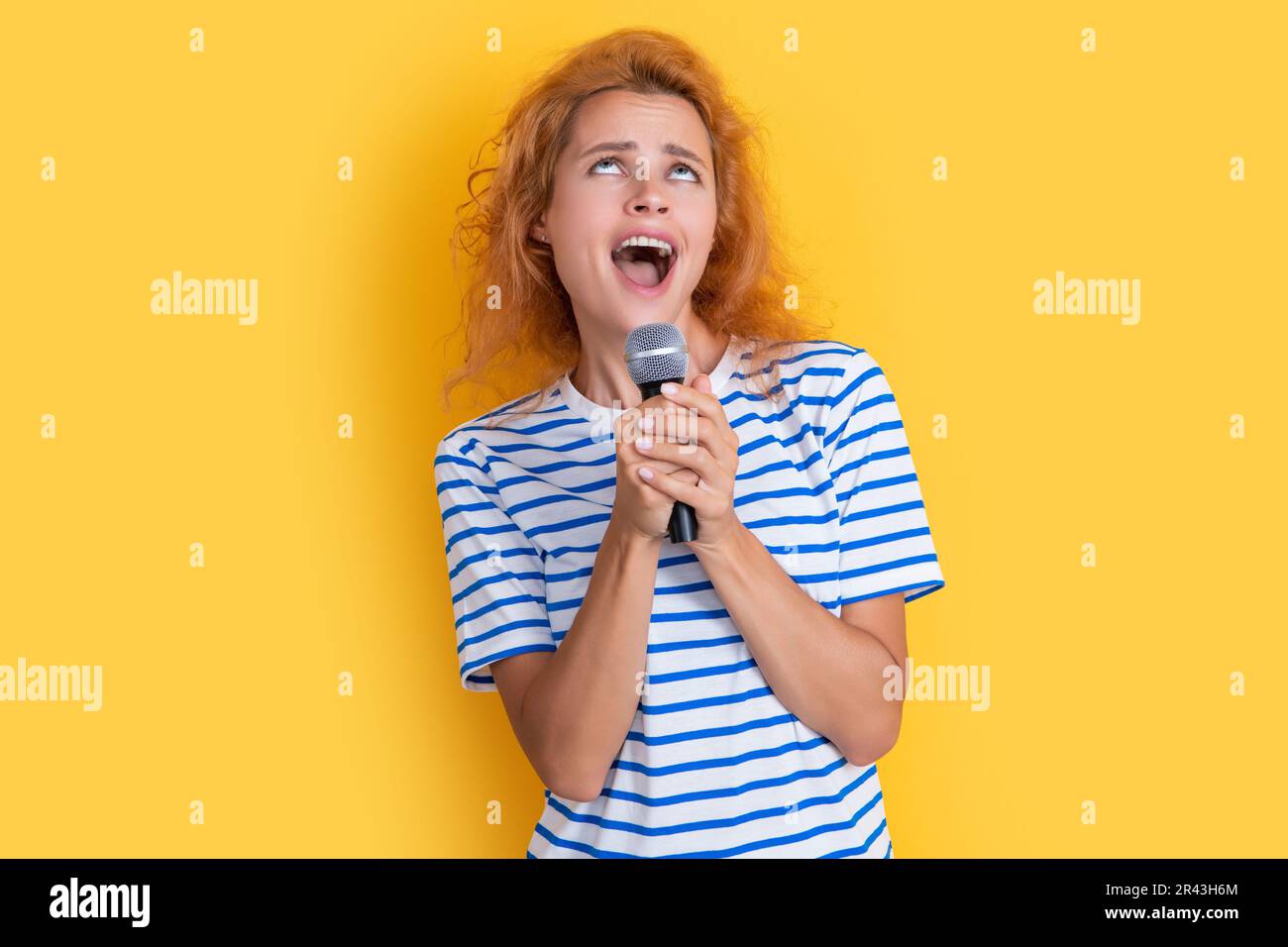 woman singer isolated on yellow background. young singer woman sing in ...