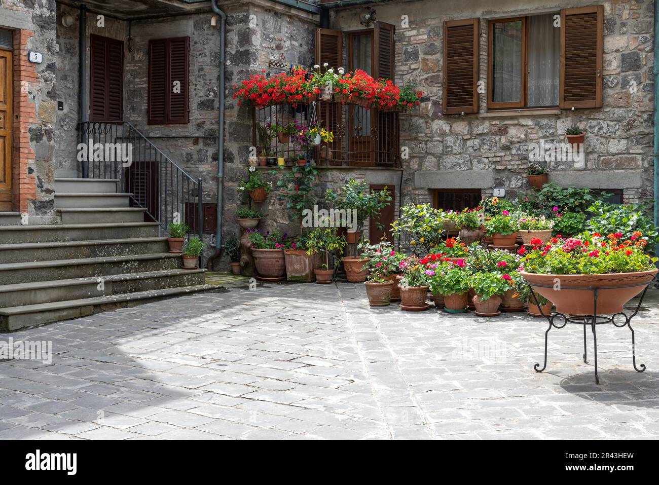 Multitude of flowers on display outside a house in Radicofani Stock ...