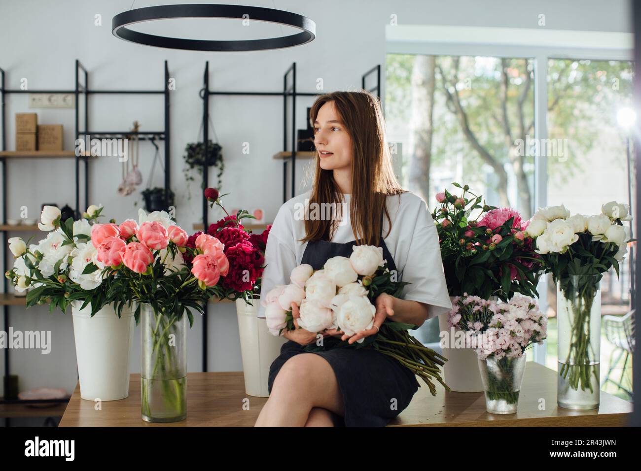 Florist woman in workspace of flower shop. - stock photo Stock Photo ...
