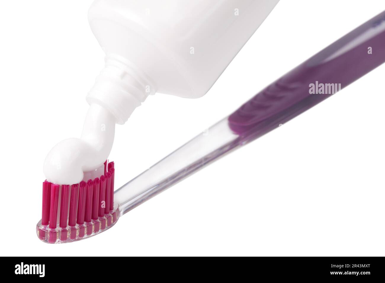 Squeezing toothpaste onto toothbrush, on a white background Stock Photo ...
