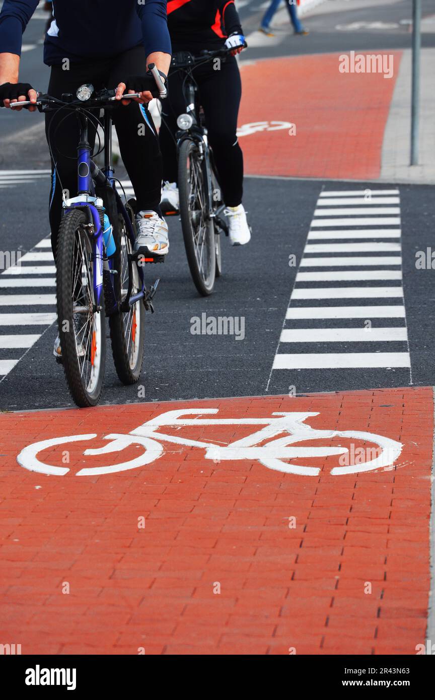 Bicycle road sign and bike rider Stock Photo - Alamy