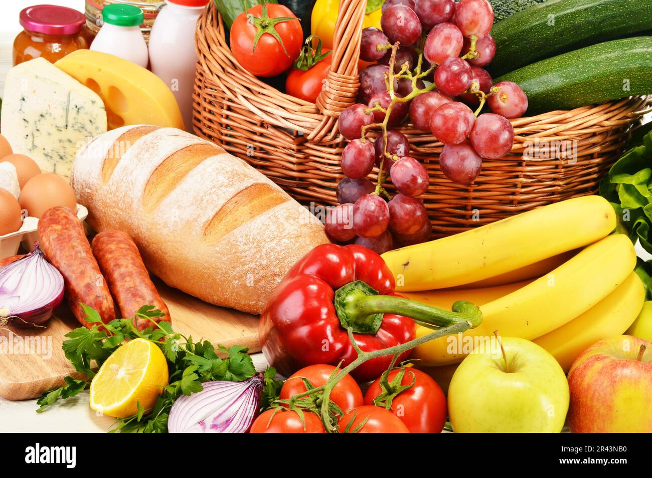 Assorted grocery products including vegetables fruits wine bread dairy ...
