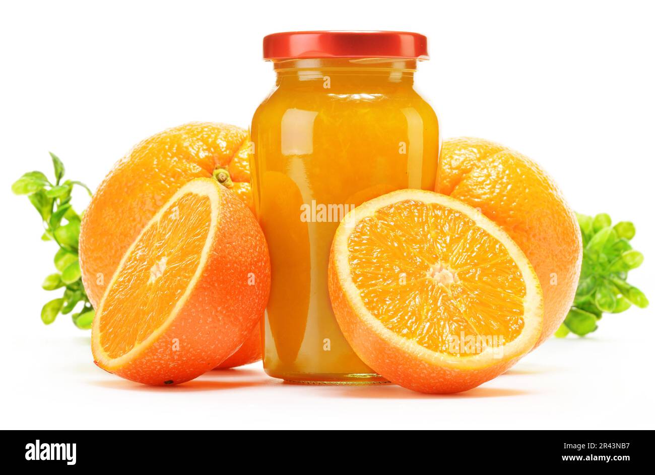 Glass and jug of orange juice, jar of jam and fruits. Variety of orange ...