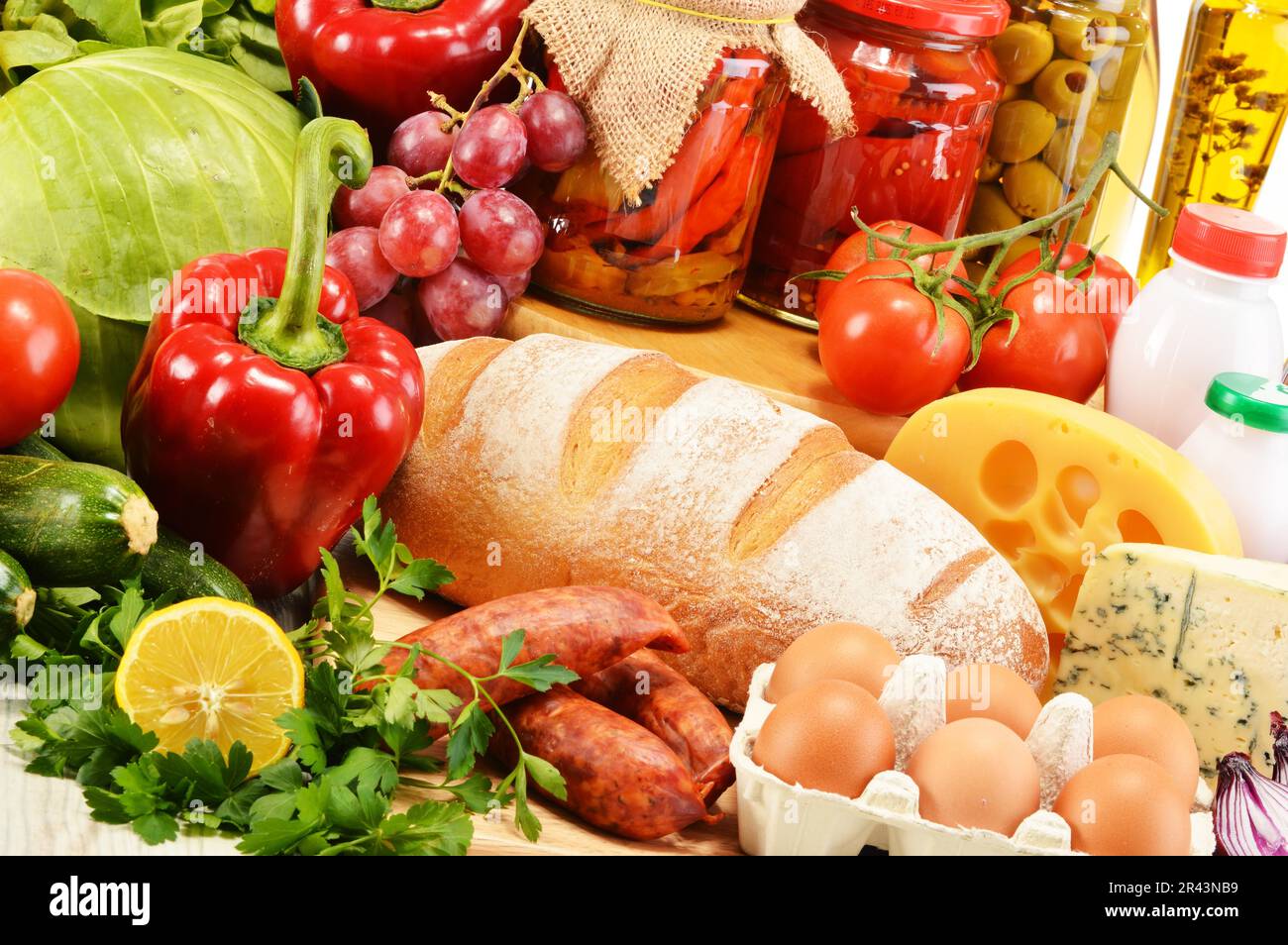Assorted grocery products including vegetables fruits wine bread dairy ...
