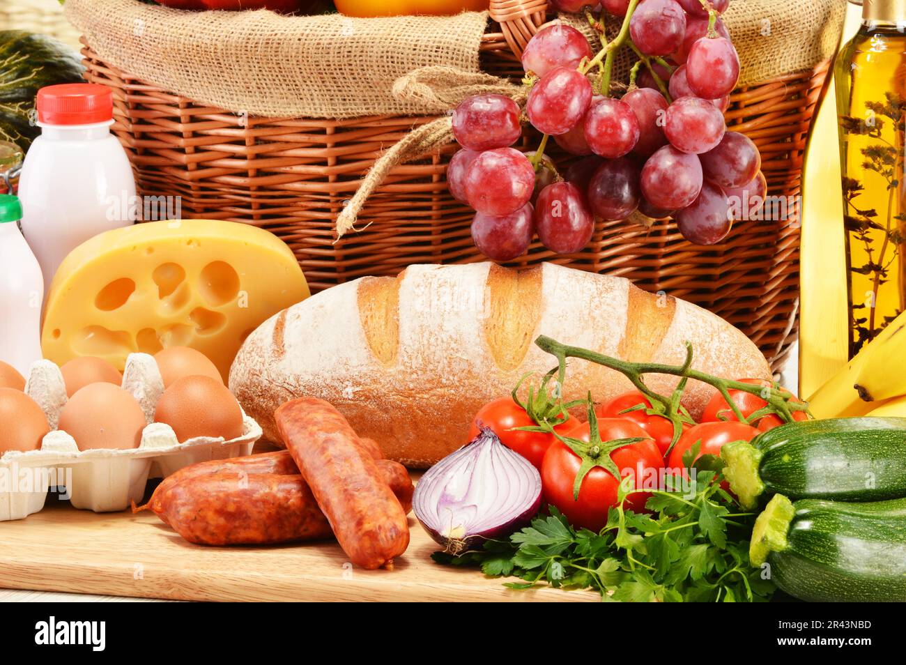 Assorted grocery products including vegetables fruits wine bread dairy ...