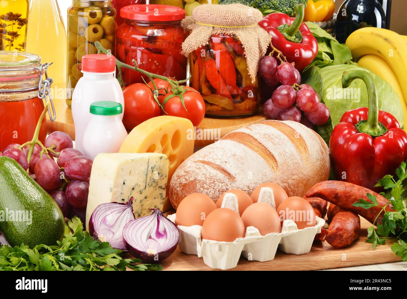 Assorted grocery products including vegetables fruits wine bread dairy ...