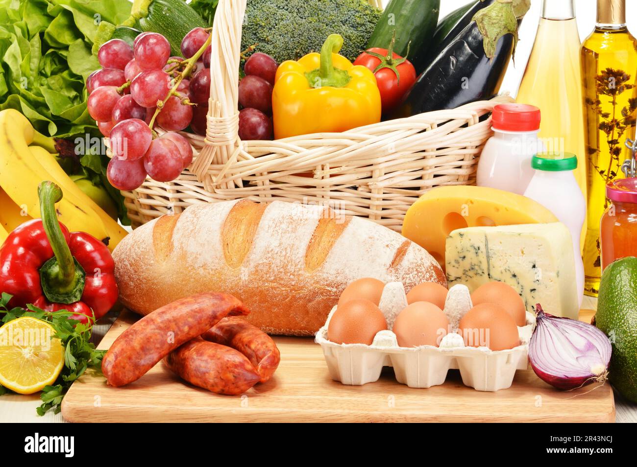 Assorted grocery products including vegetables fruits wine bread dairy ...