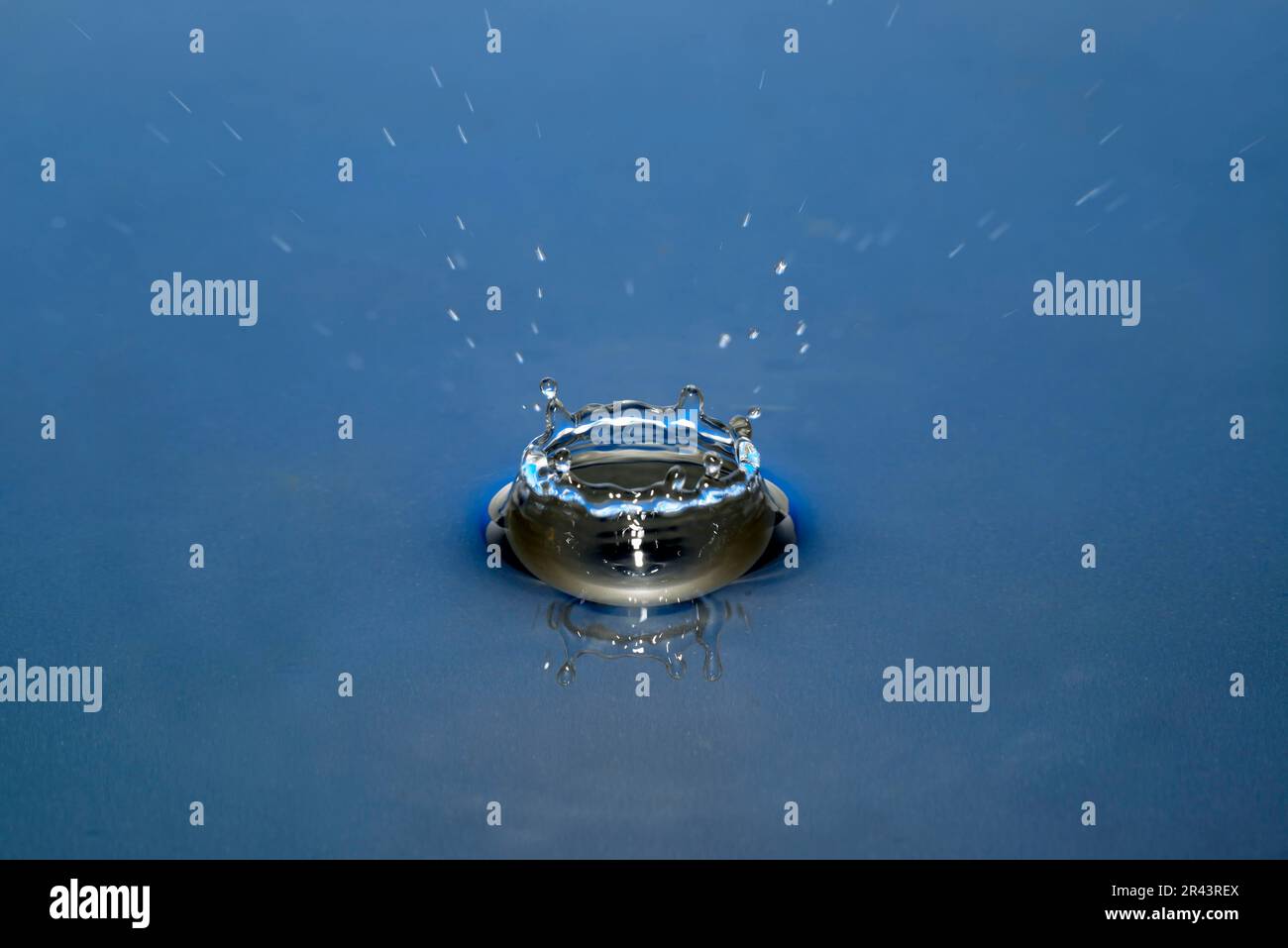 Water drop falls on water surface Stock Photo - Alamy