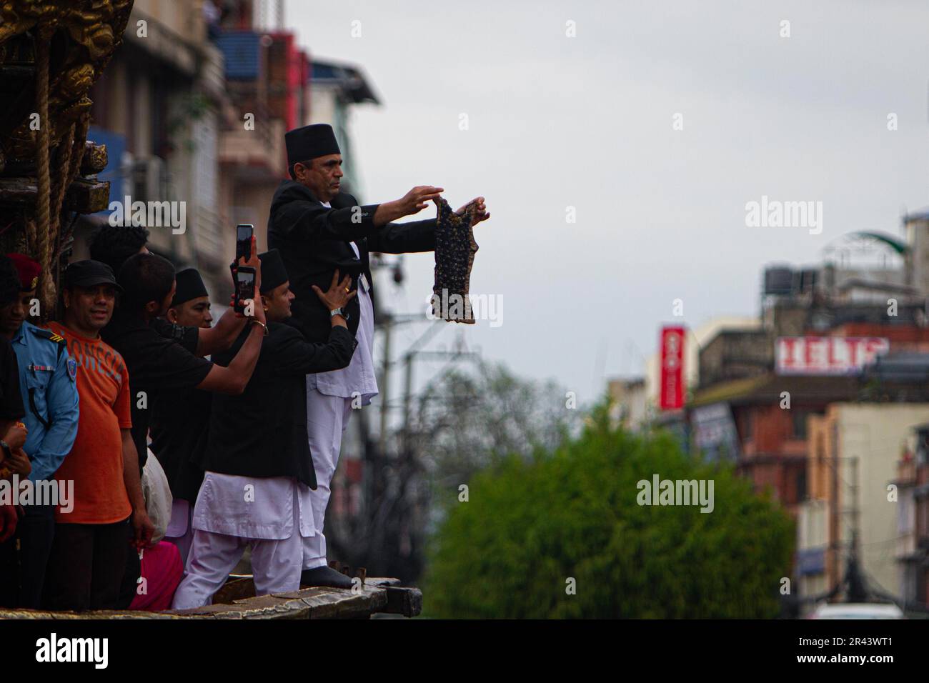 A Nepalese Guthi Sansthan member displaying the black jewel-studded ...