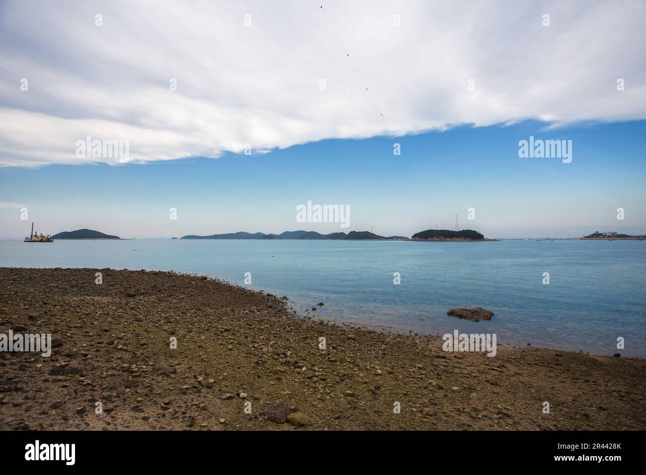 a sandy beach contrasting with a sky full of clouds Stock Photo - Alamy