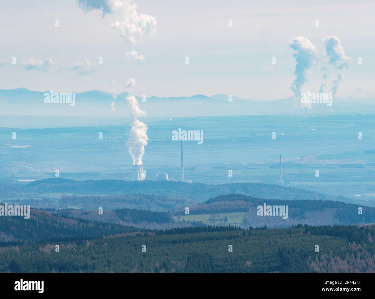 Smoking coal-fired power plant and steam cloud above cooling tower ...