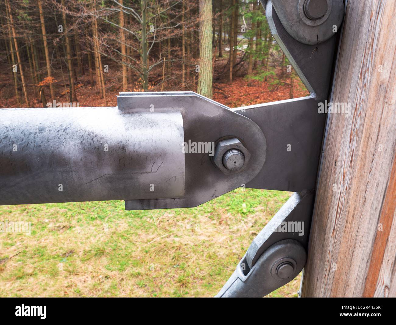 Steel beam and screwed anchor bolt. Support tube on main wooden support ...