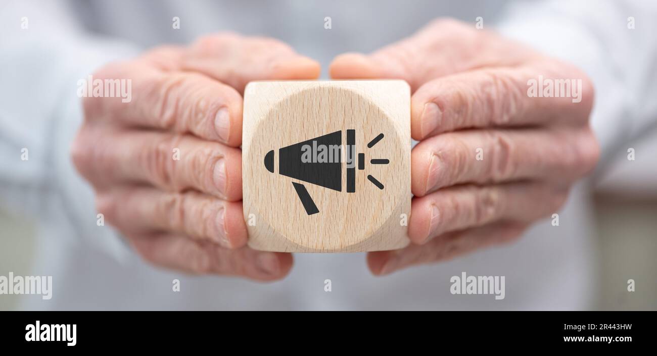 Hand holding a wooden cube with symbol of communication concept Stock ...