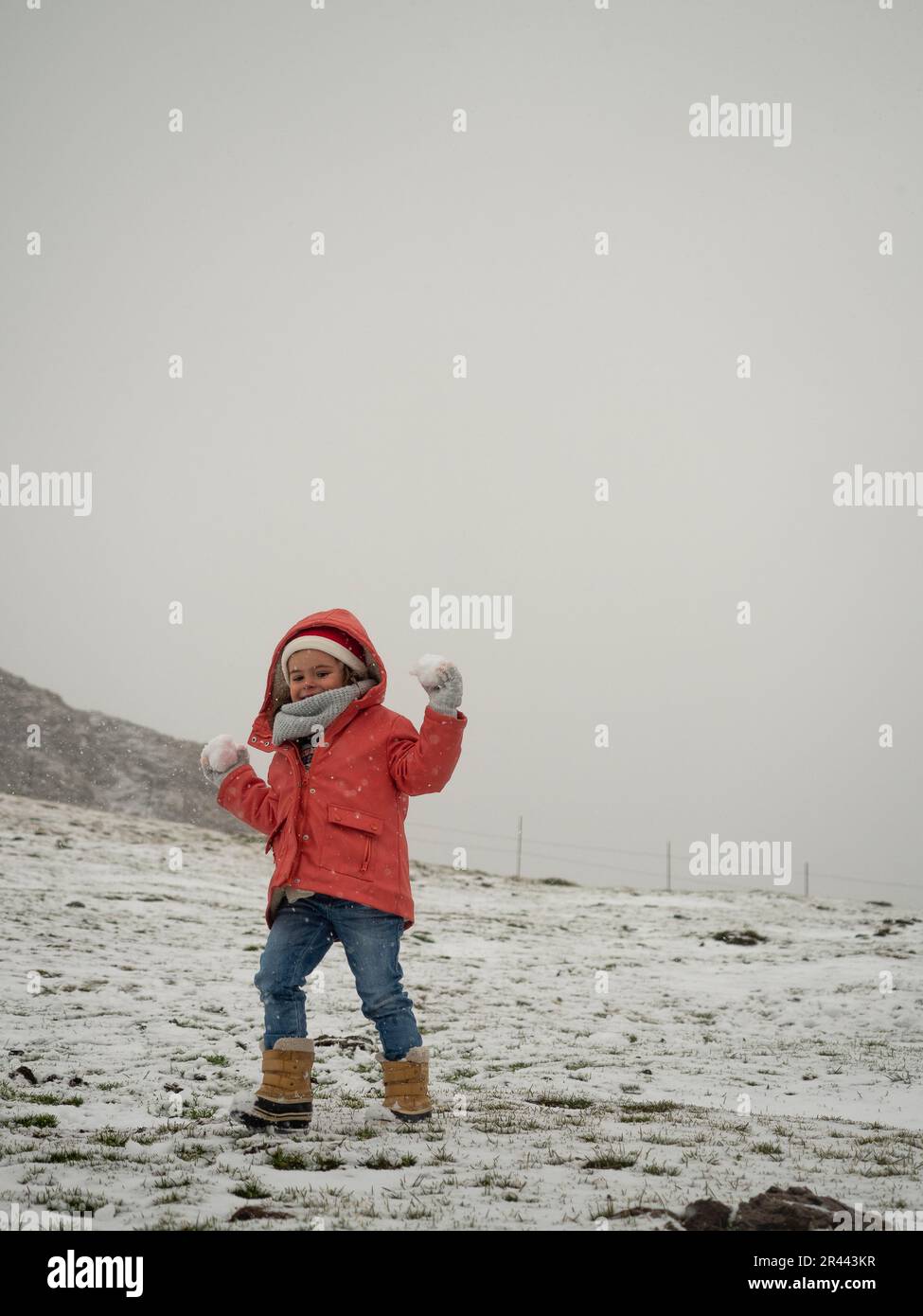 Little girl with snowballs Stock Photo - Alamy