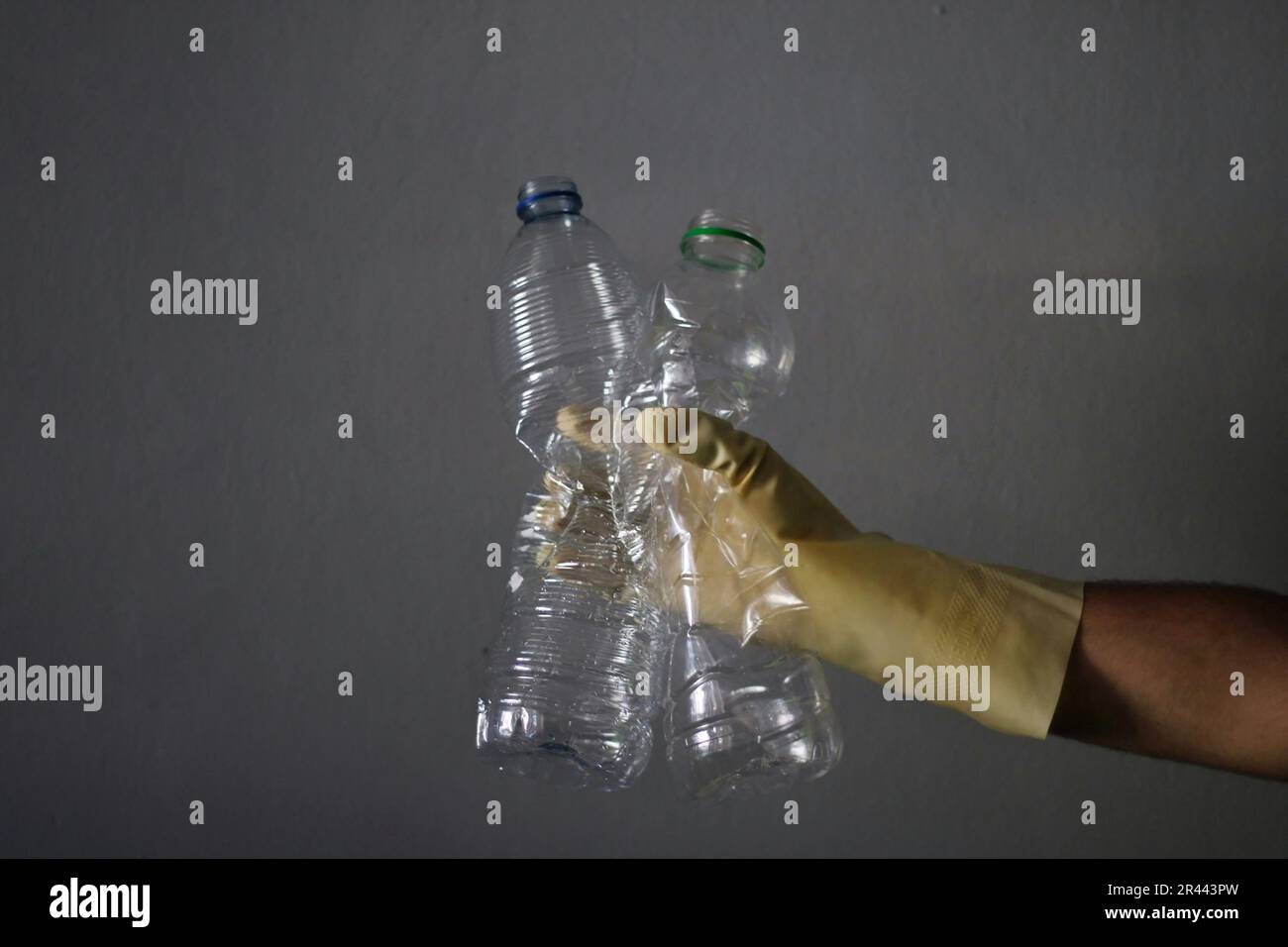 Man with gloves recycling some plastic bottles Stock Photo - Alamy