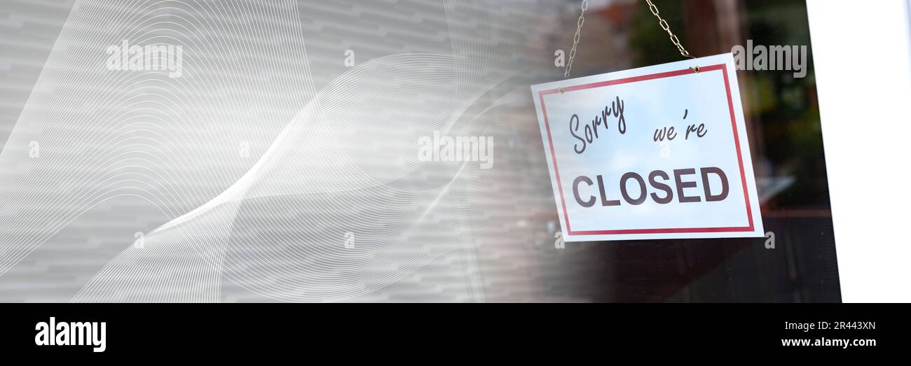 Sorry we're closed sign hanging behind a store window; panoramic banner ...