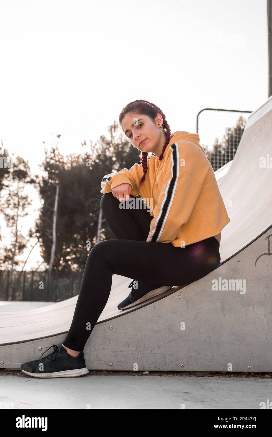 Young woman with street clothes on a skating rink Stock Photo - Alamy