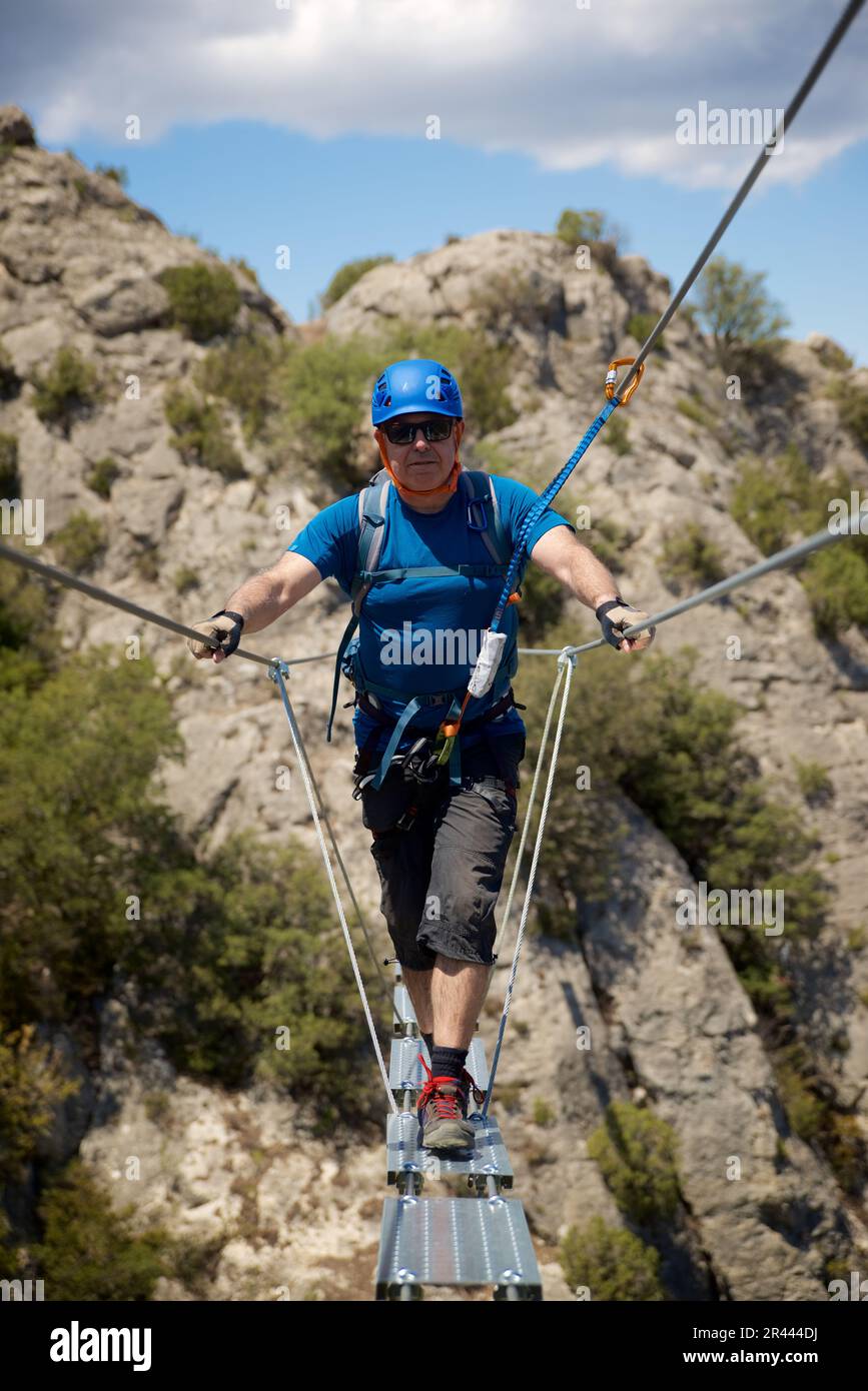 Crossing a Tibetan bridge during via ferrata climbing in Spain Stock ...