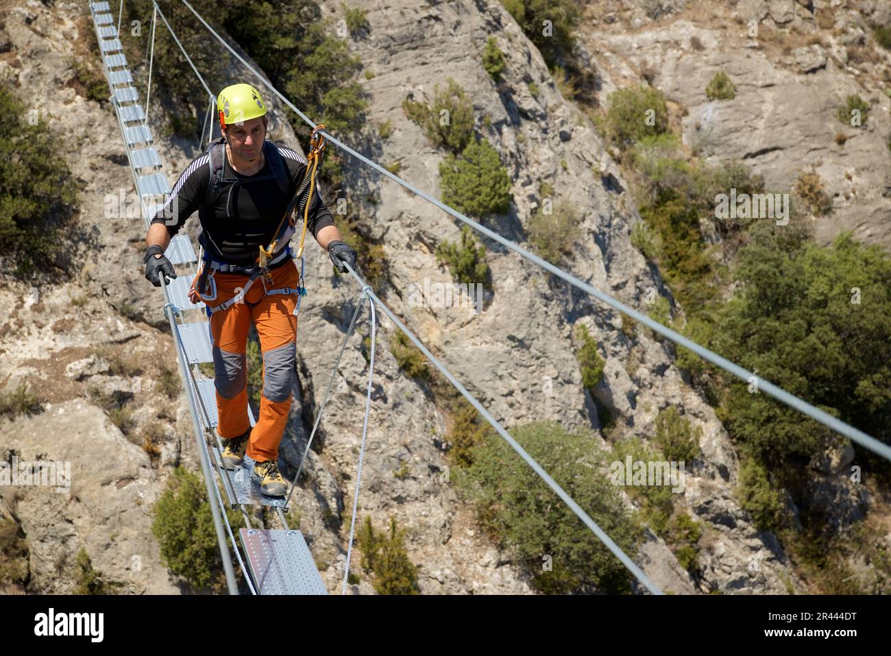 Crossing a Tibetan bridge during via ferrata climbing in Spain Stock ...