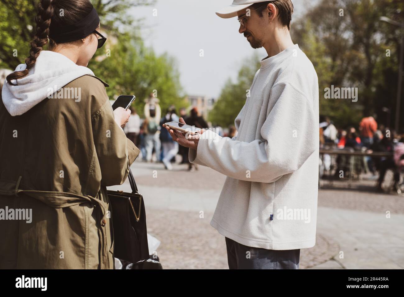 man uses device to pay for sale of second hand goods at flee market ...
