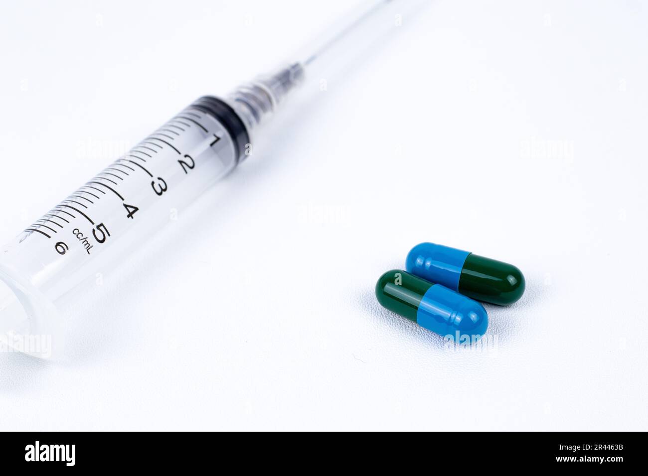 Disposable plastic syringe and capsule medicine isolated on white ...