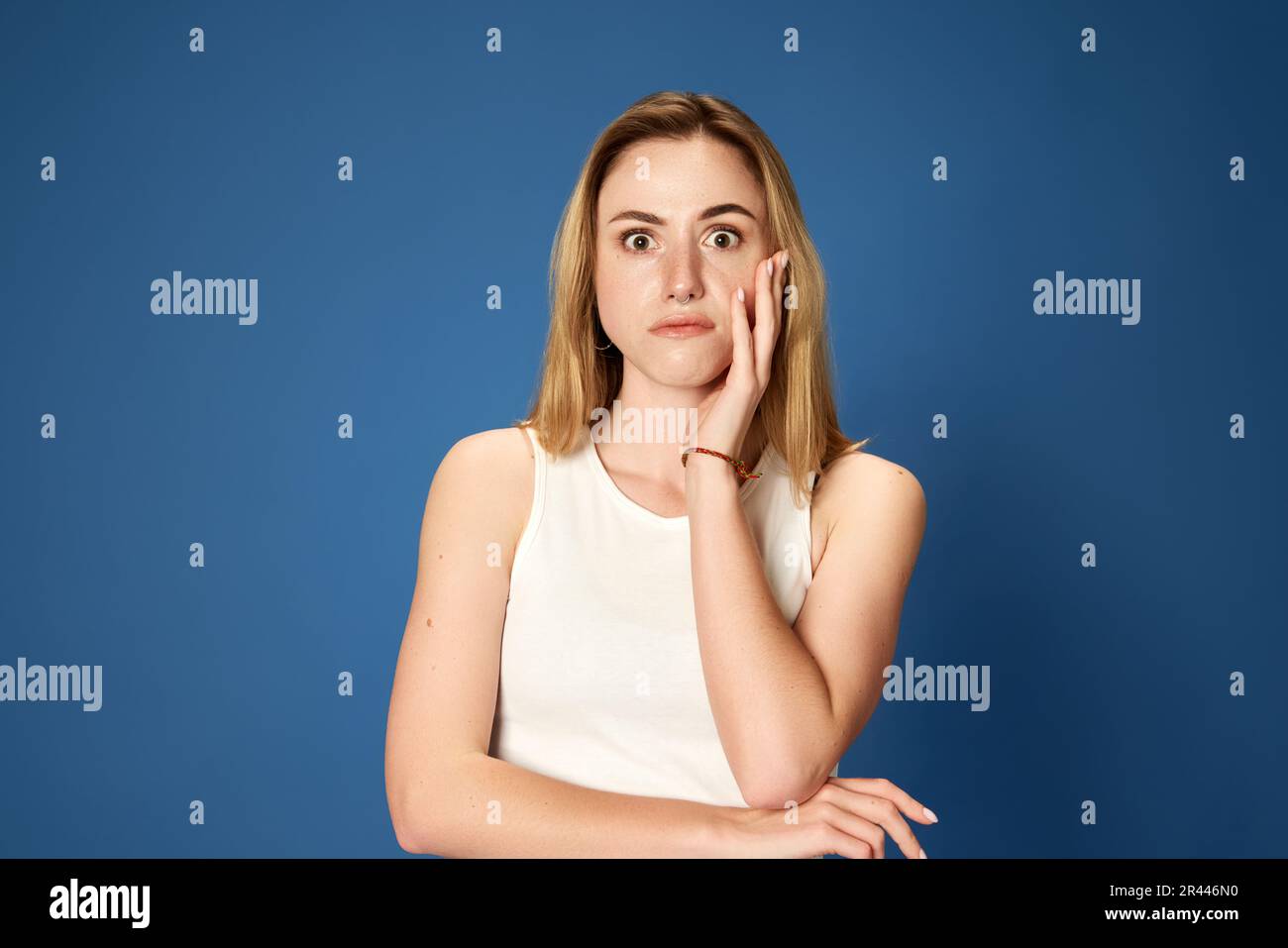 Portrait of young girl in casual clothes showing emotion of shock ...