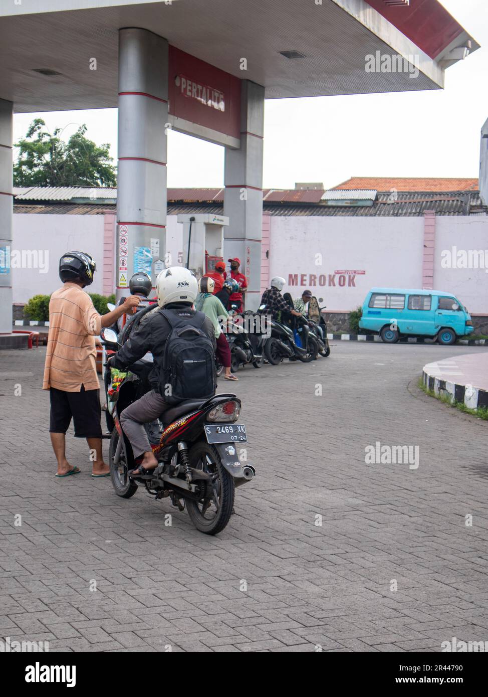 Queue of motorcycles are queuing to do refueling in Pertamina Gas ...