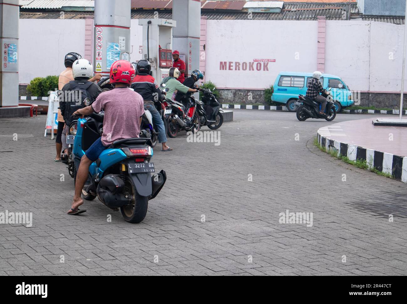 Queue of motorcycles are queuing to do refueling in Pertamina Gas ...