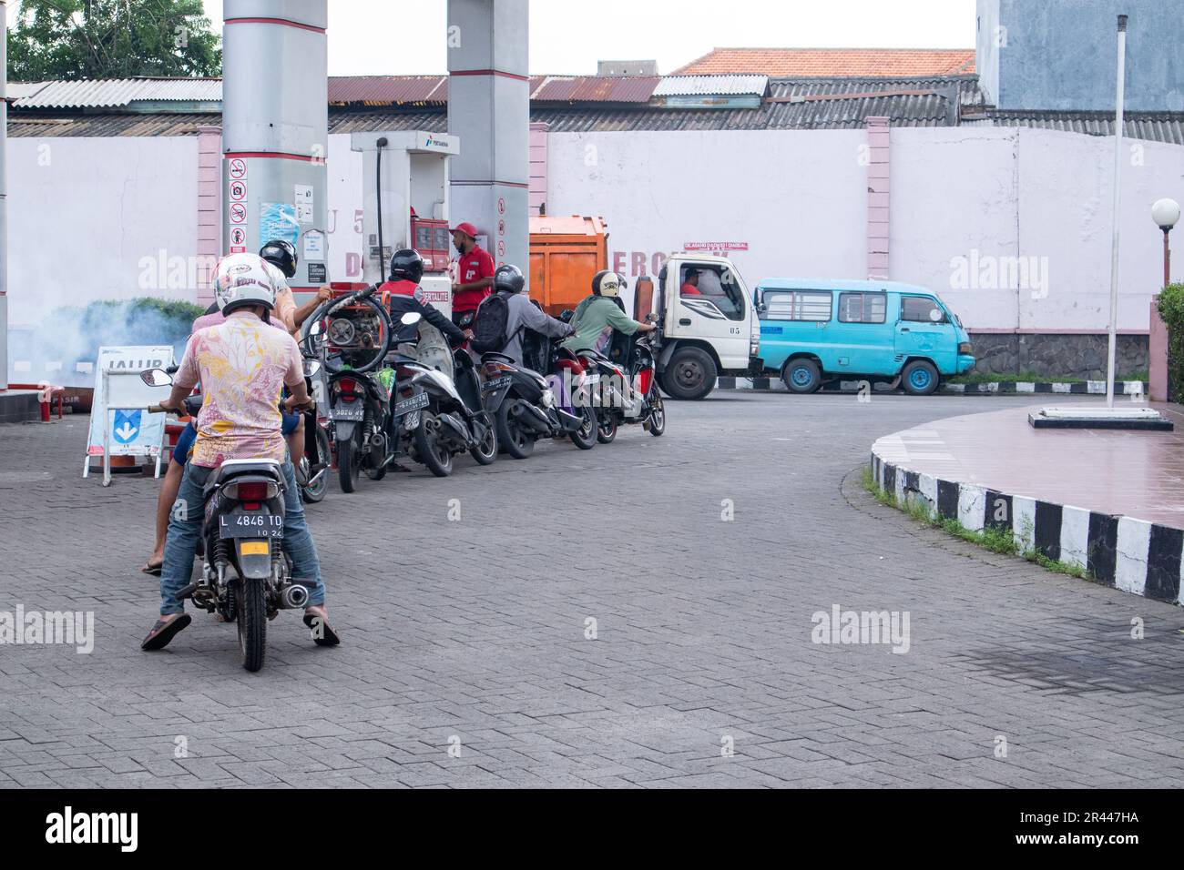 Queue of motorcycles are queuing to do refueling in Pertamina Gas ...