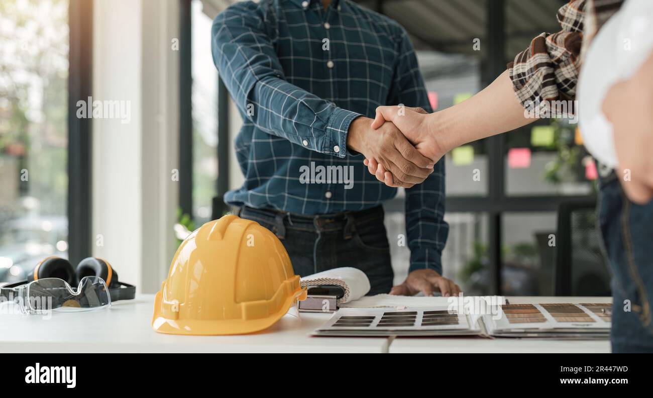 Engineer and contractor shaking hands success of the project work ...