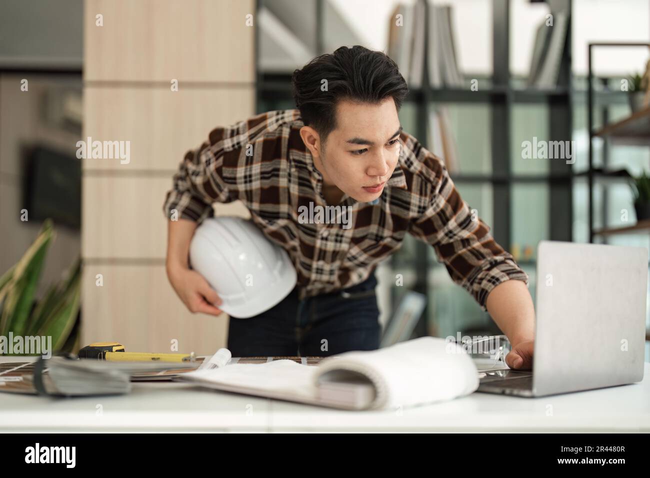 Engineer working in office with blueprints. Engineer inspect ...