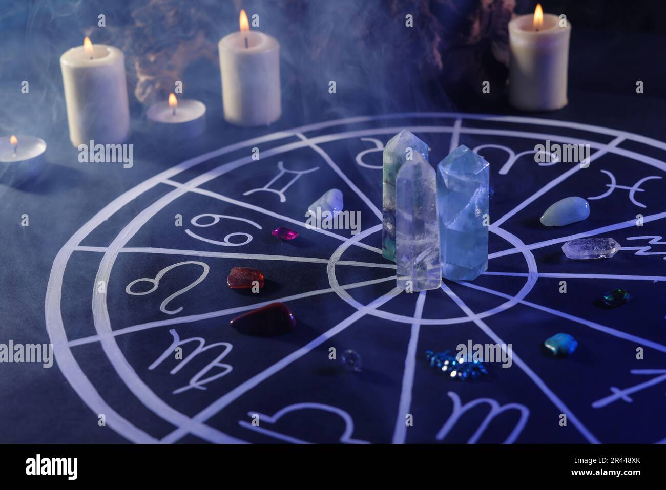Natural stones for zodiac signs, drawn astrology chart and burning ...