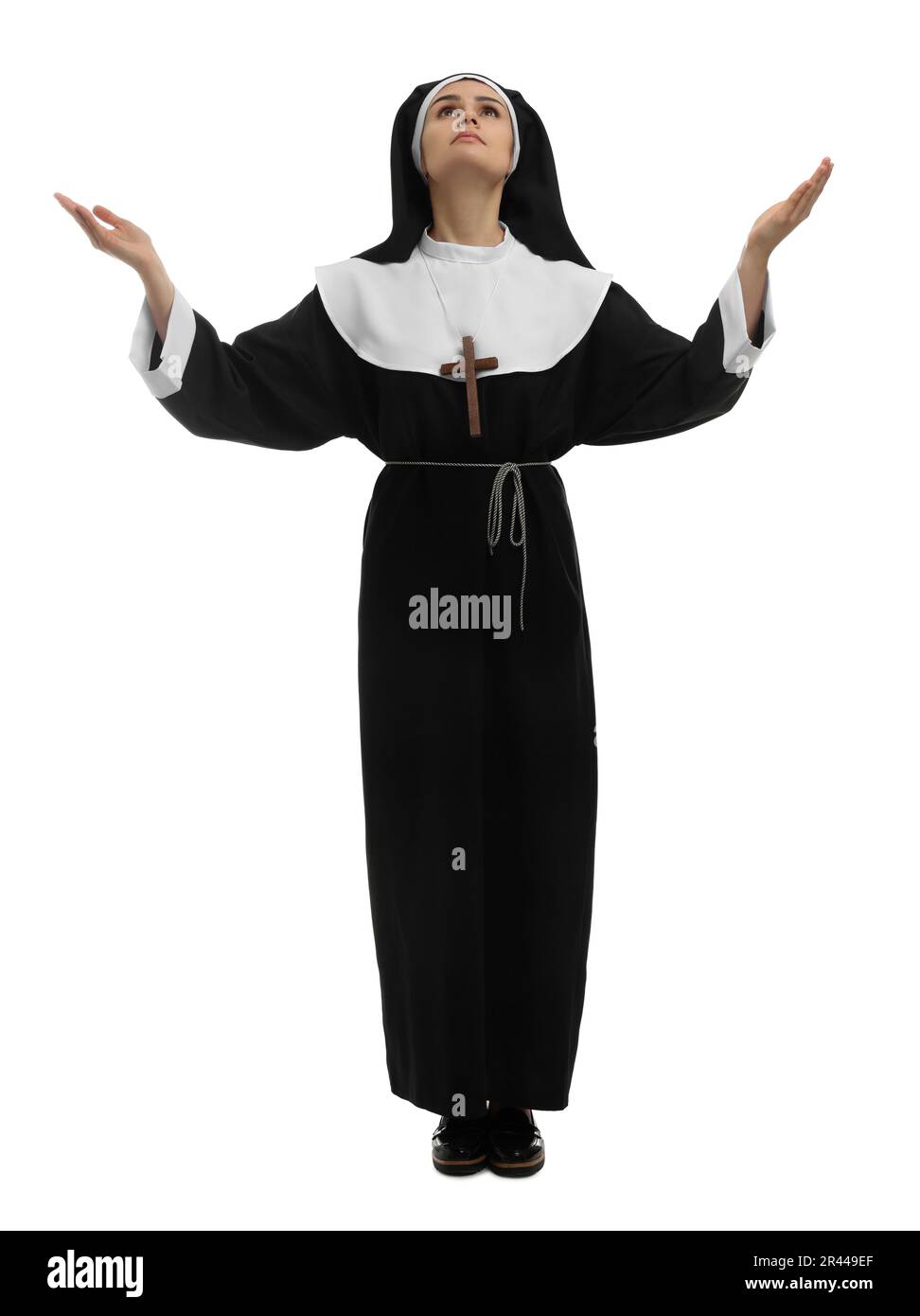 Nun praying to God on white background Stock Photo - Alamy