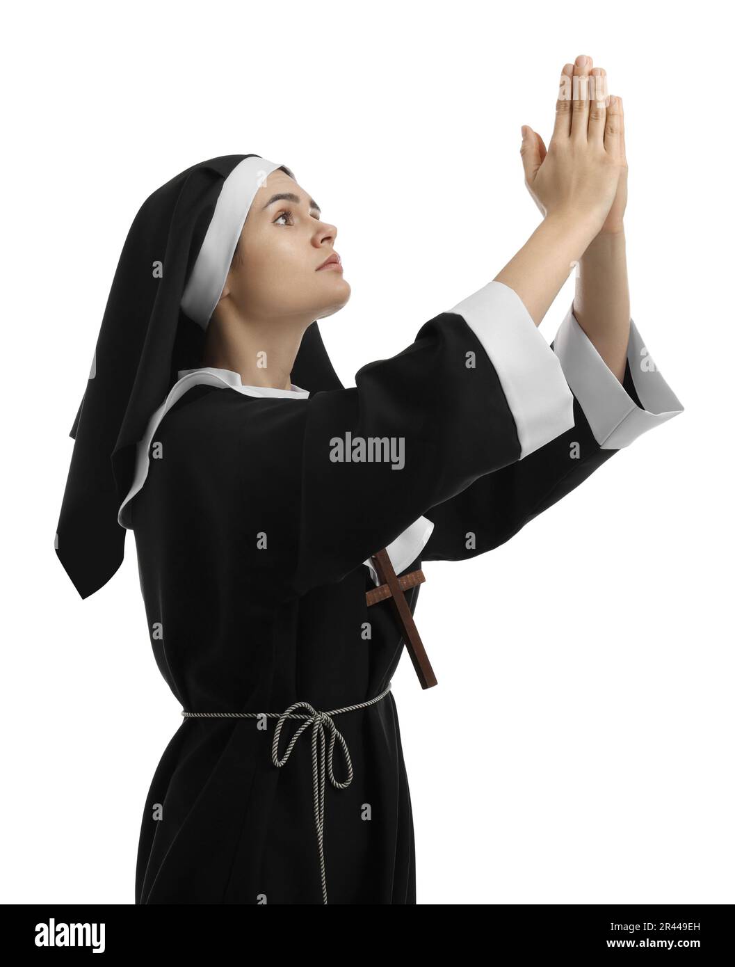 Nun with clasped hands praying to God on white background Stock Photo ...