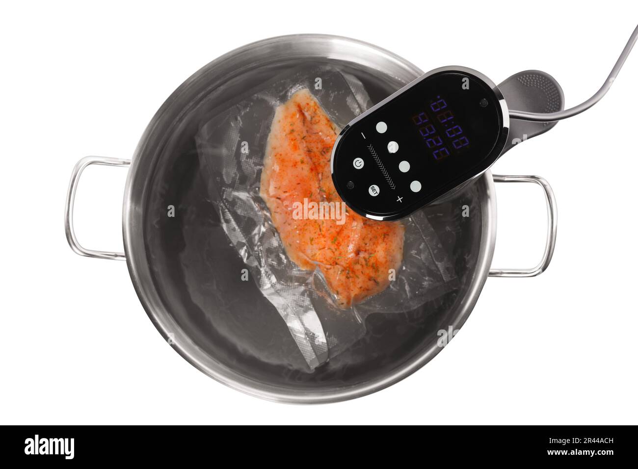 Thermal immersion circulator and vacuum packed meat in pot on white ...