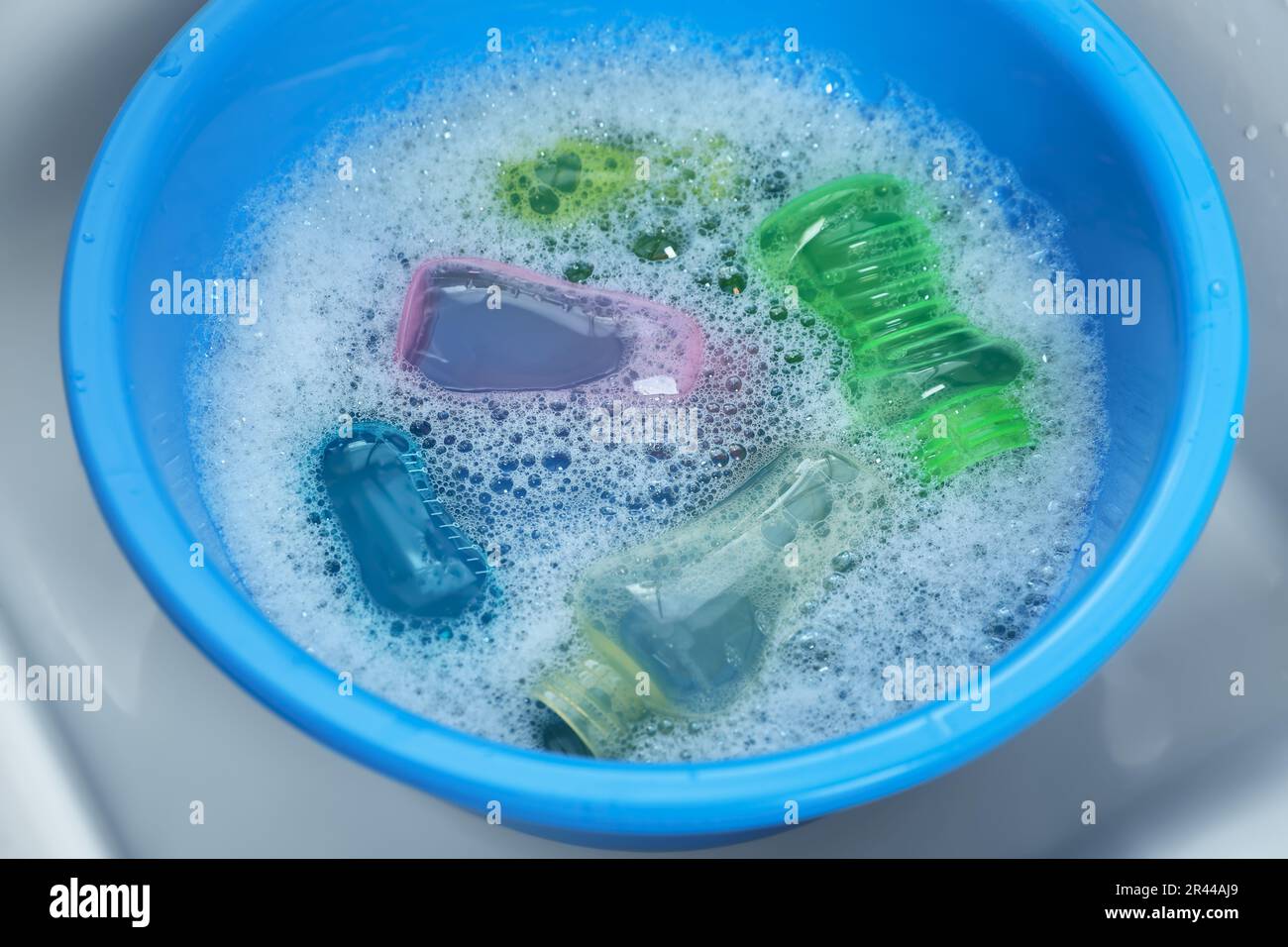 Light blue basin with baby bottles, above view Stock Photo - Alamy