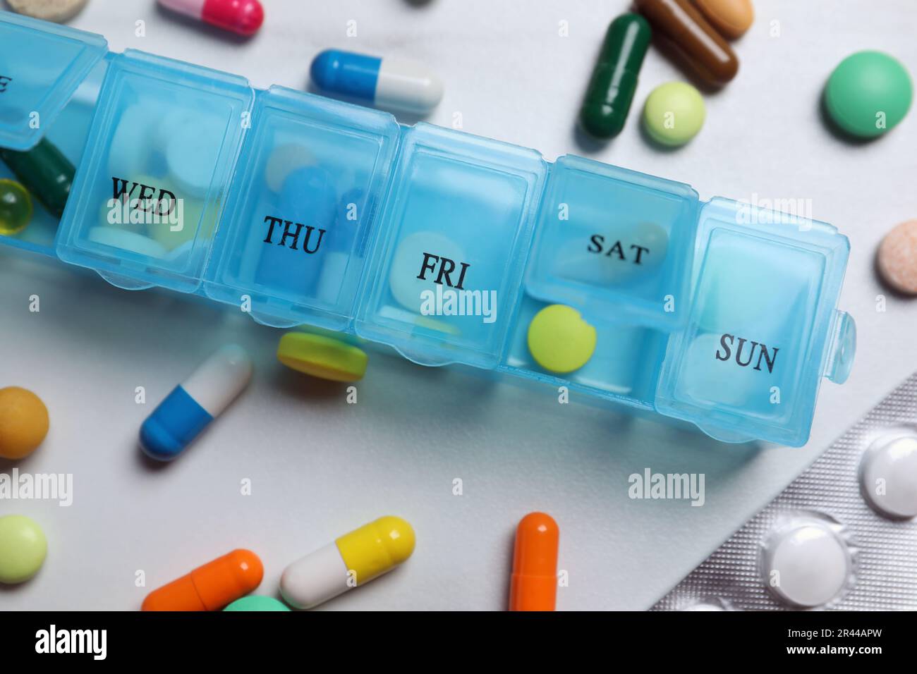 Weekly pill box with medicaments on white table, flat lay Stock Photo ...
