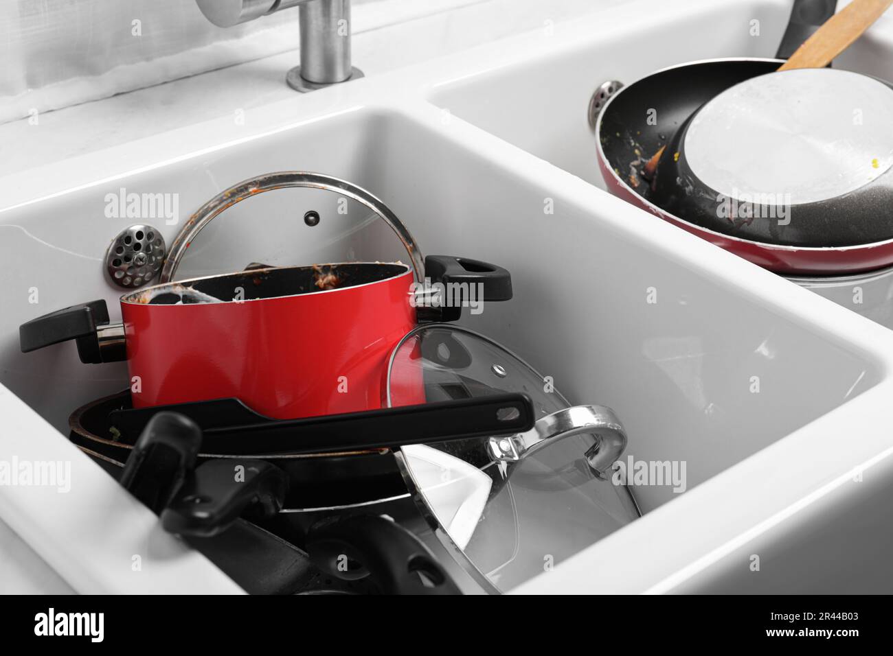 Messy pile of dirty kitchenware in sink Stock Photo - Alamy