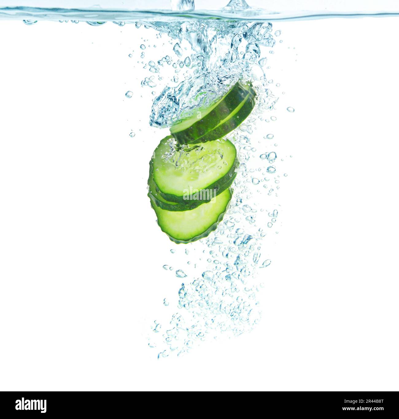 Fresh cucumber slices in water on white background Stock Photo - Alamy