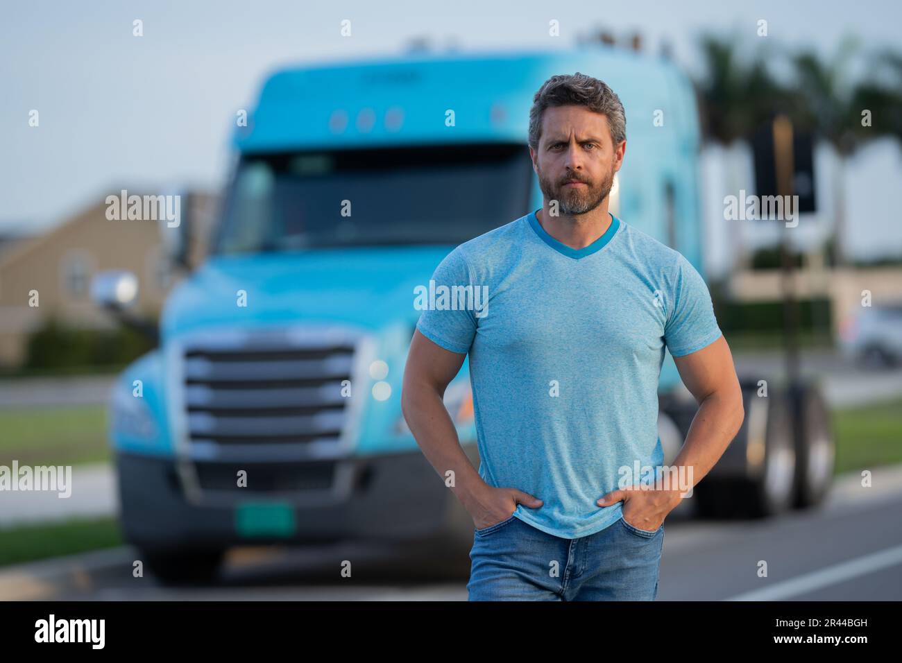 Men driver near lorry truck. Truck driver in safety vest near truck ...