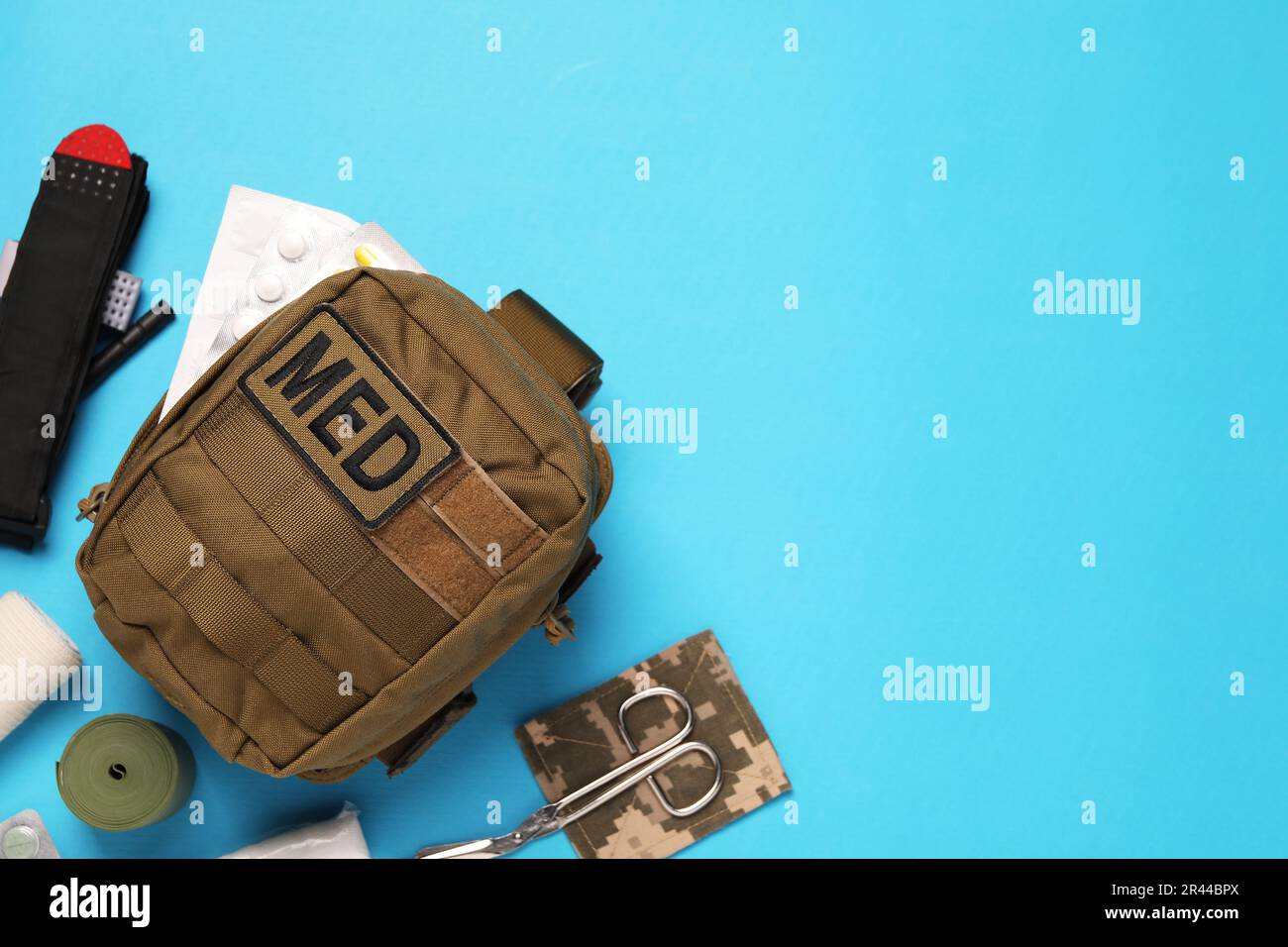 Military first aid kit and equipment on light blue background, flat lay ...