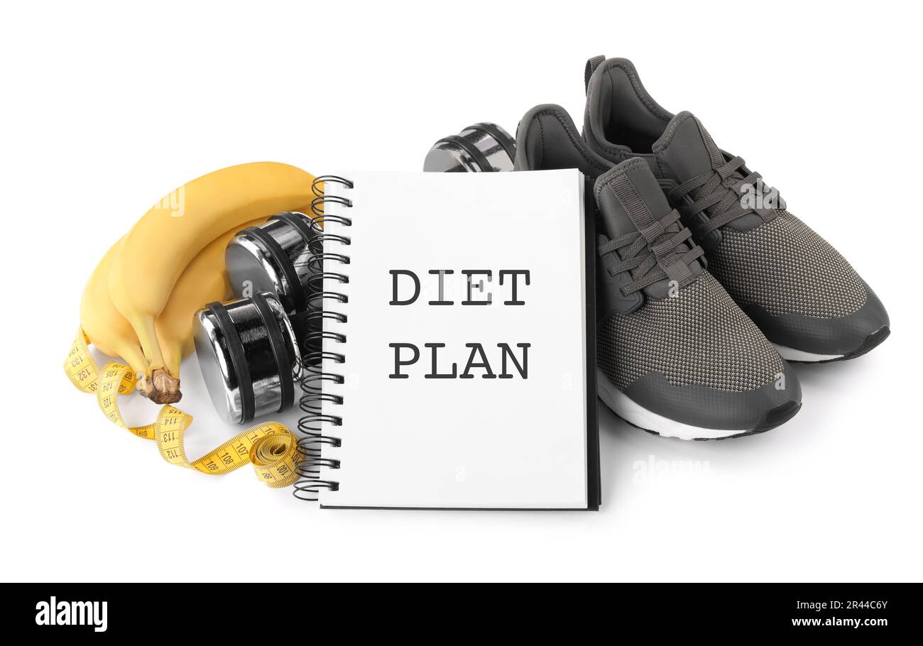 Notebook with phrase Diet Plan, fitness items and bananas on white ...